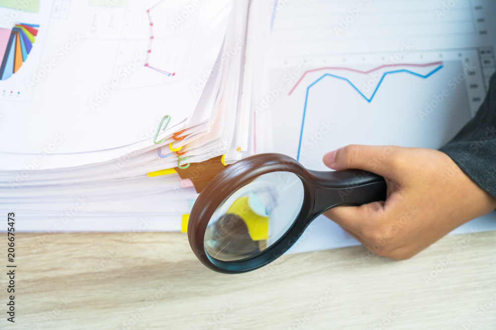 Asian Businessman use Magnifying glass scaning documents for checking ...