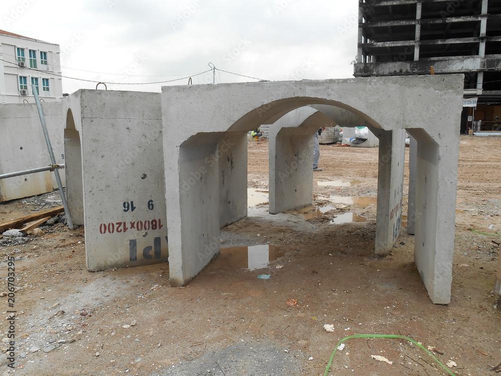 Precast concrete u-shape drain stock stacked at the construction site ...