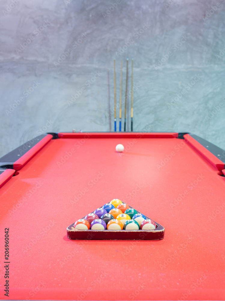 Billiard ball on red table background in pub bar room concept for sport ...