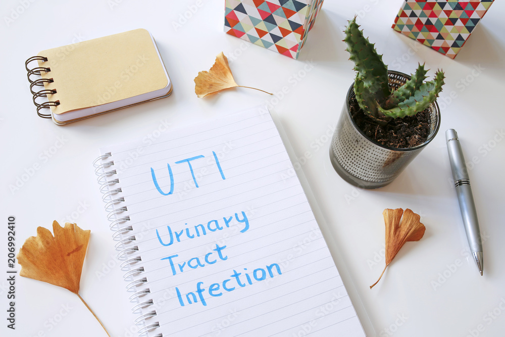 UTI Urinary Tract Infection written in notebook on white table Stock ...