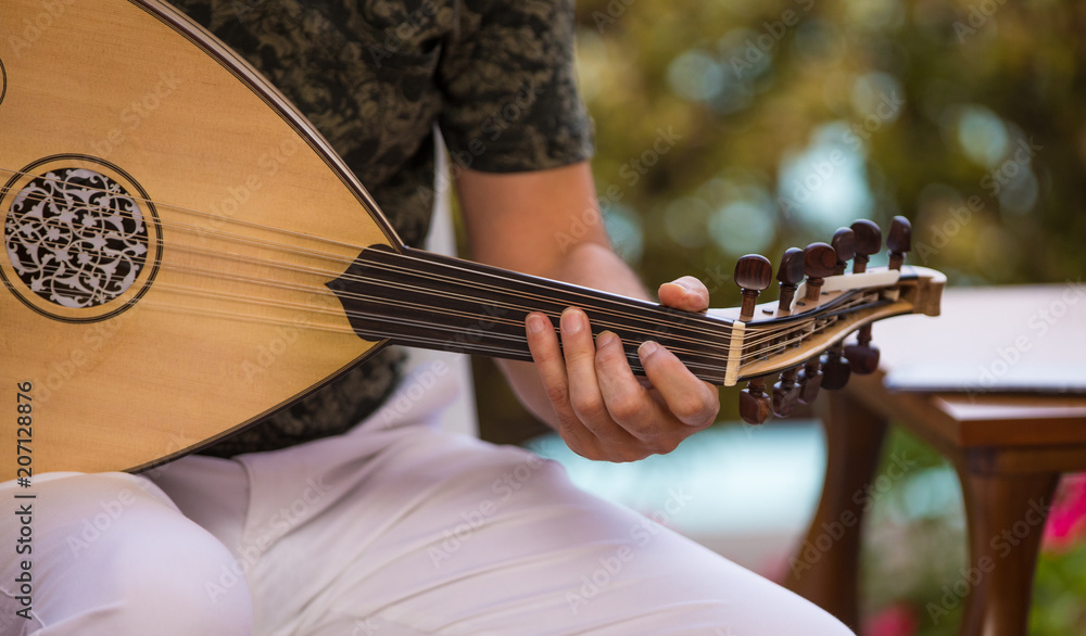 playing an Arabic stringed musical instrument Stock Photo | Adobe Stock