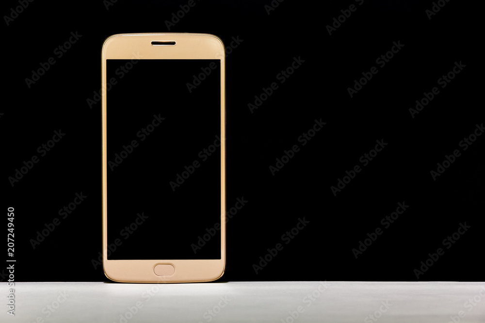 Blush gold color smartphone on the white floor with black background ...
