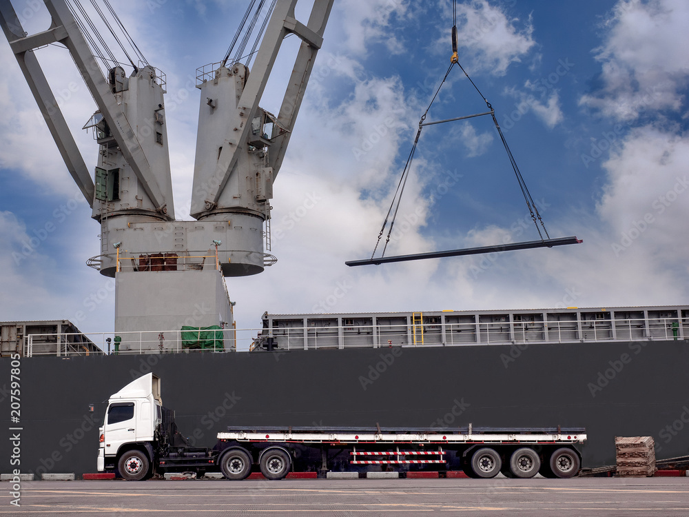 The vessel loading steel billet from truck to onboard at industrial ...