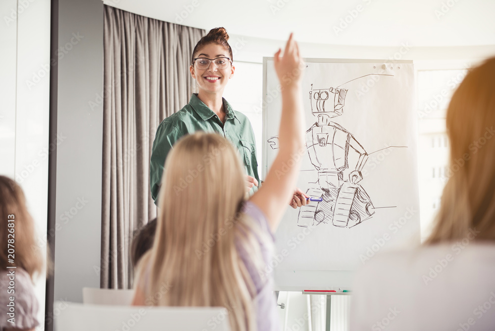 Stock-Foto „What is it. Happy teacher showing on picture. Girl rising ...