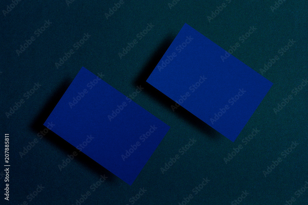 Mock up of two horizontal blue business cards at dark blue textured ...