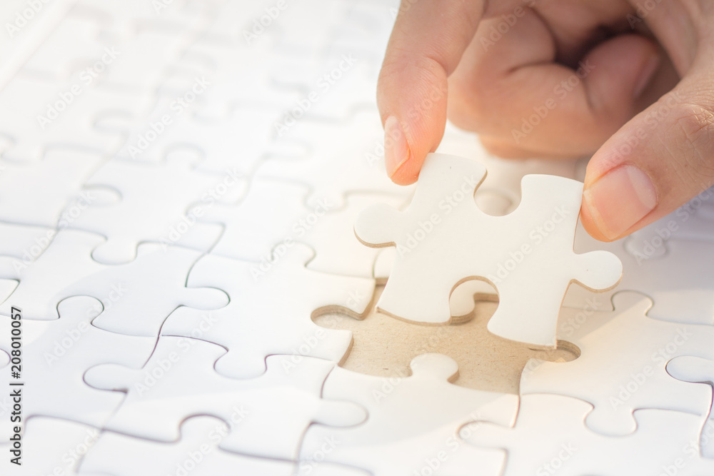 Hands put puzzle pieces last jigsaw puzzle, business concept for ...
