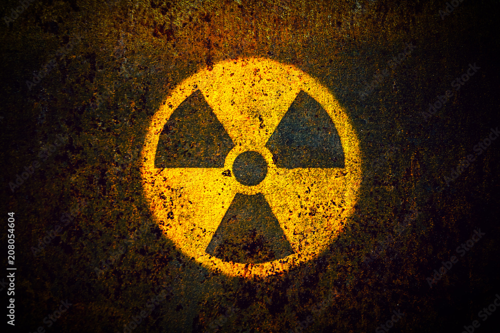 Round yellow radioactive (ionizing radiation) danger symbol painted on ...