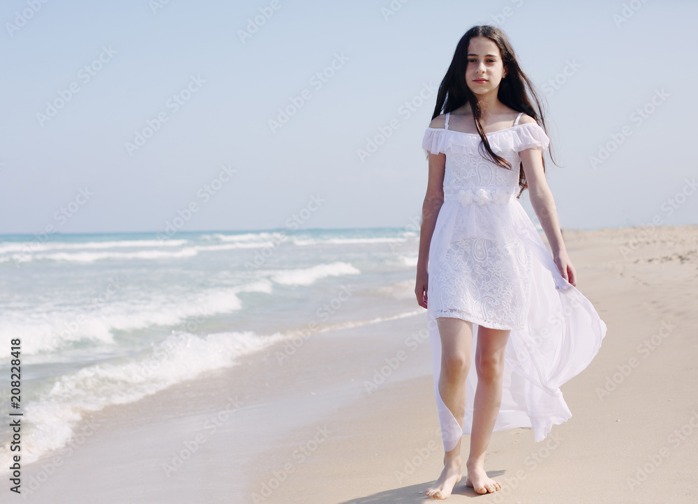 Portrait of adorable 12 years old girl walking alone on the beach in ...
