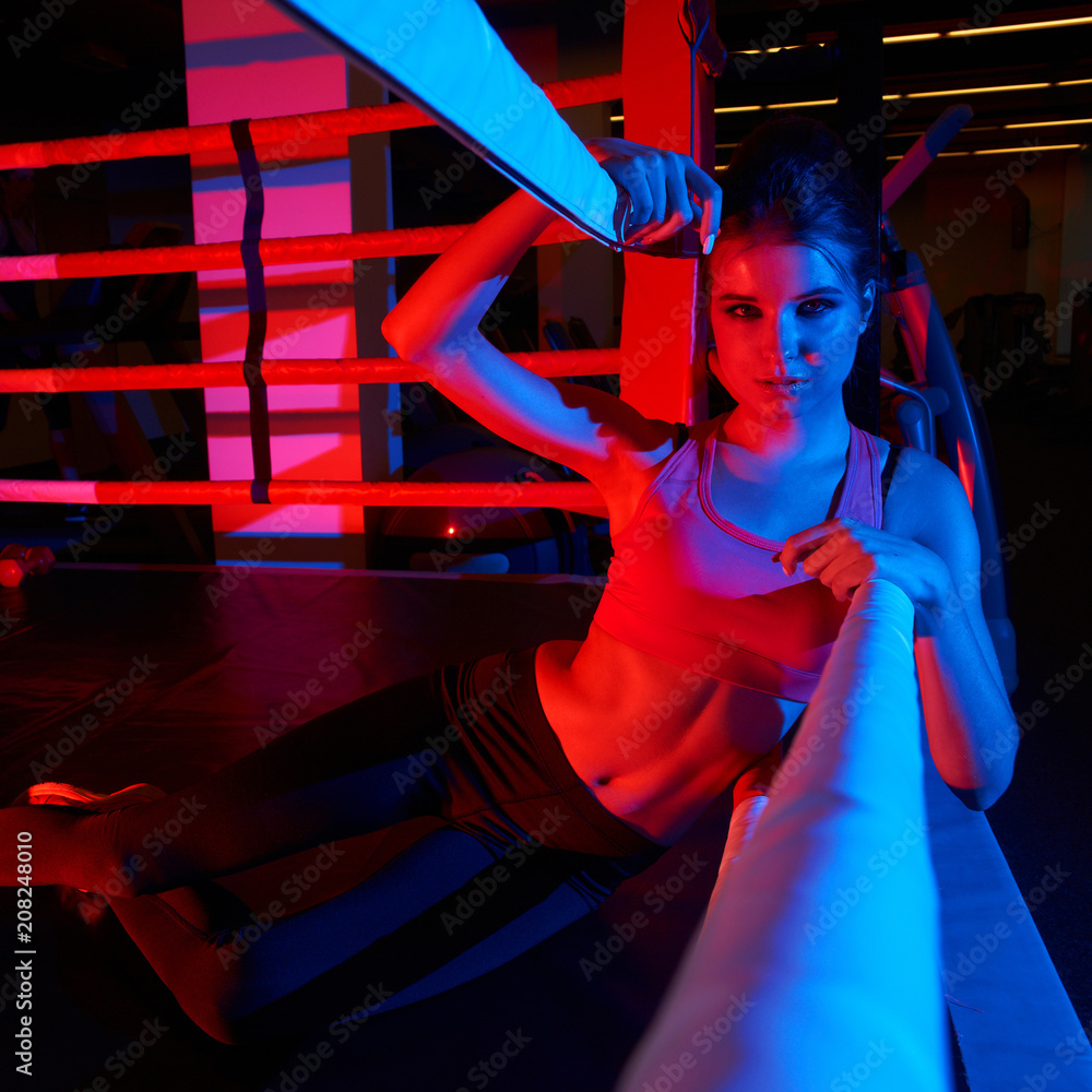 Seductive female fitness model with pony tail hairstyle, dressed in ...