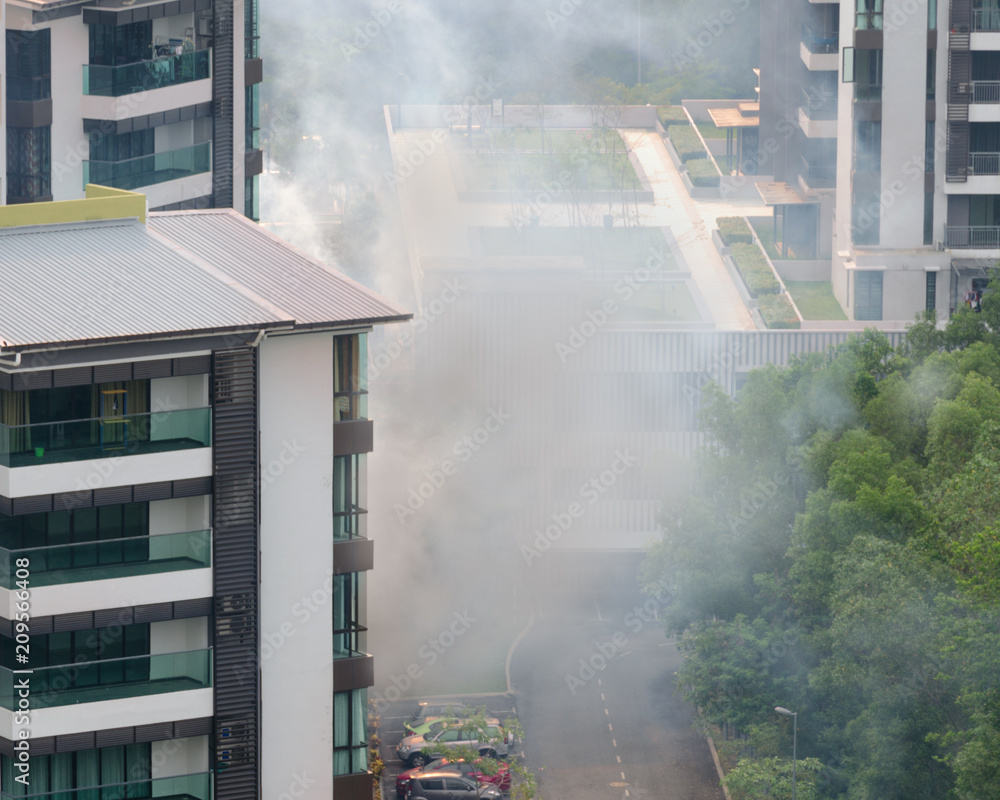 Thick smoke comes from windows of residential high-rise building. Stock ...