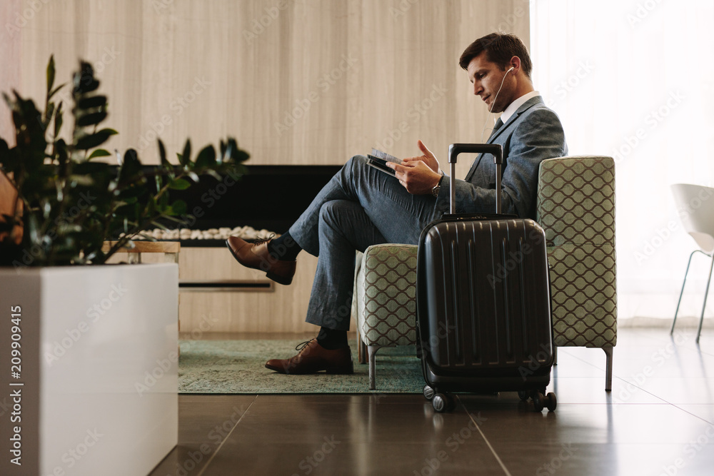 Businessman reading magazine in airport waiting room Stock Photo ...