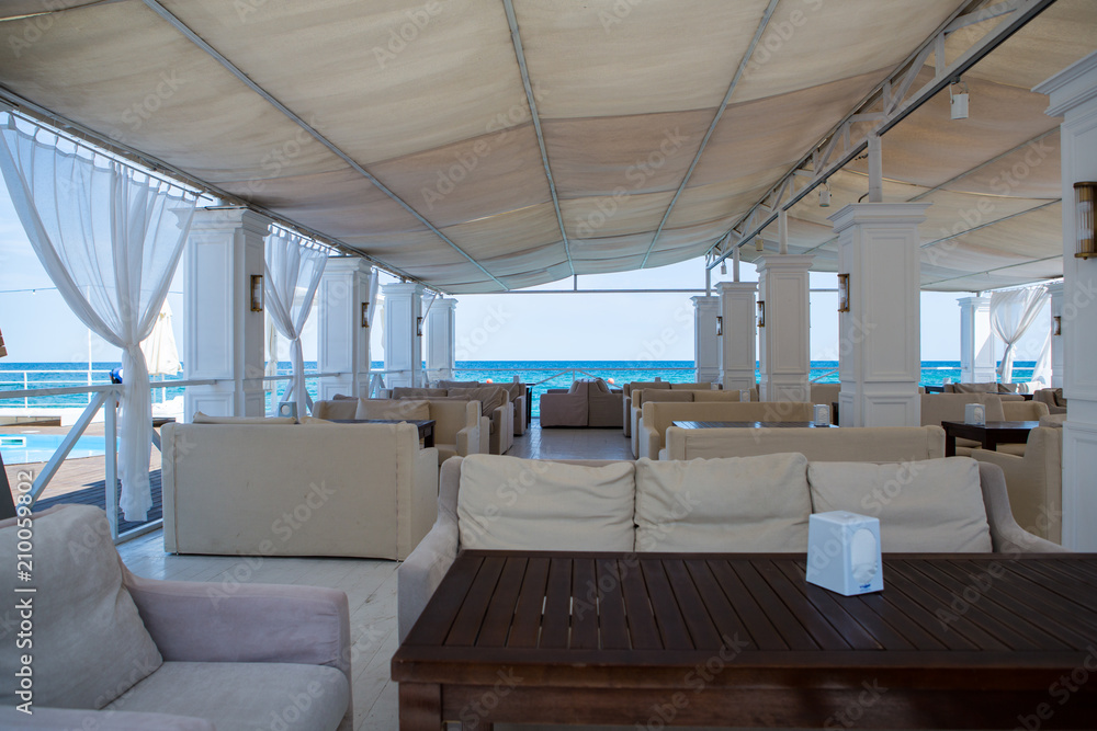 Interior of Elite comfortable beach resort with palm trees and pools ...