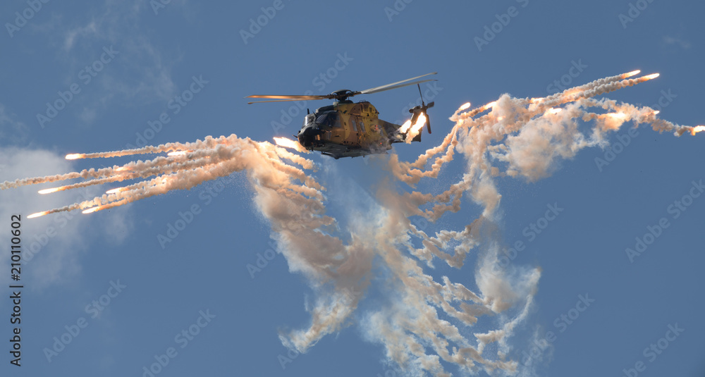 Military helicopter shooting flares Stock Photo | Adobe Stock