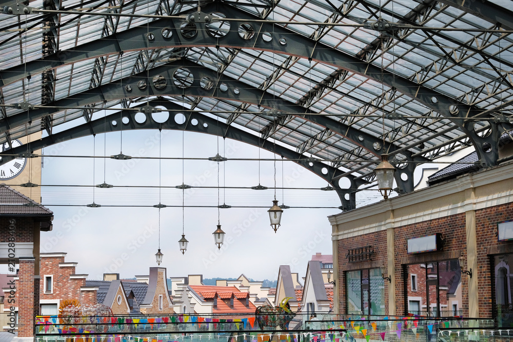 Glass roof with lanterns of huge modern shopping mall. Internal ...