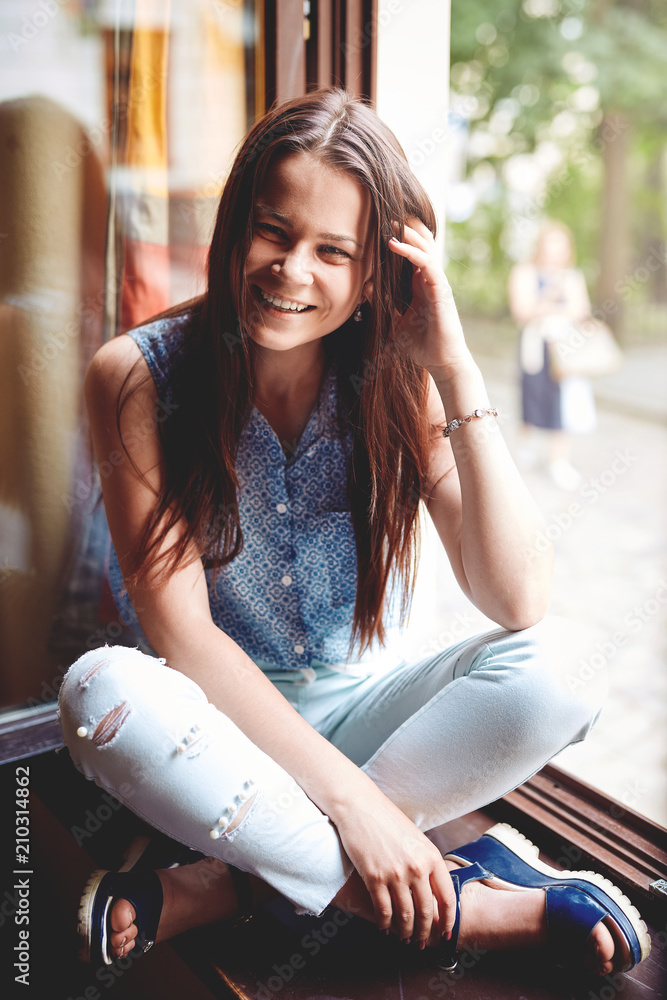 young girl in coffeeshop sitting on the window sill Stock Photo | Adobe ...