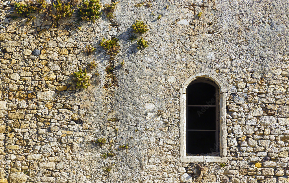 Arch window in old stone wall of medieval castle, horizontal image with ...