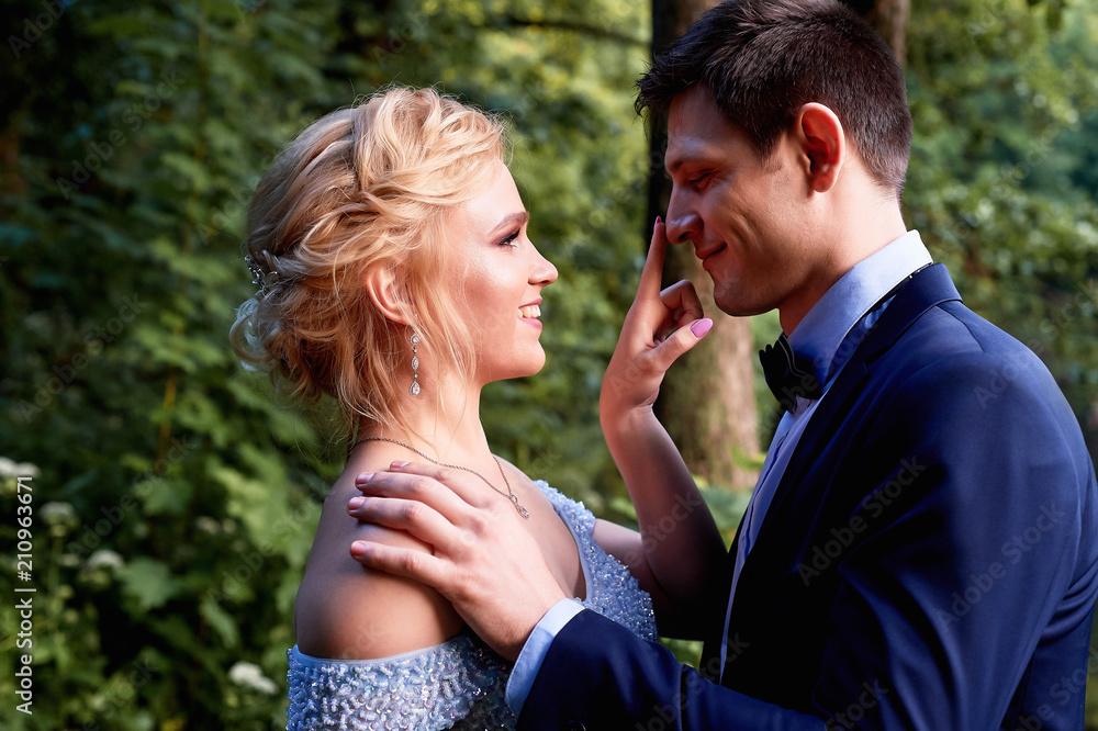 The bride looks at the groom jokingly. And touched a finger to the tip ...
