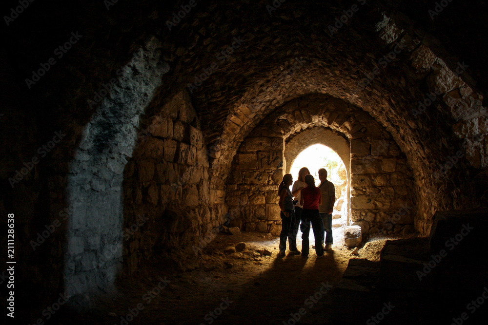 KERAK, JORDAN - Nov 2009: A small group of tourists stand in a dark ...
