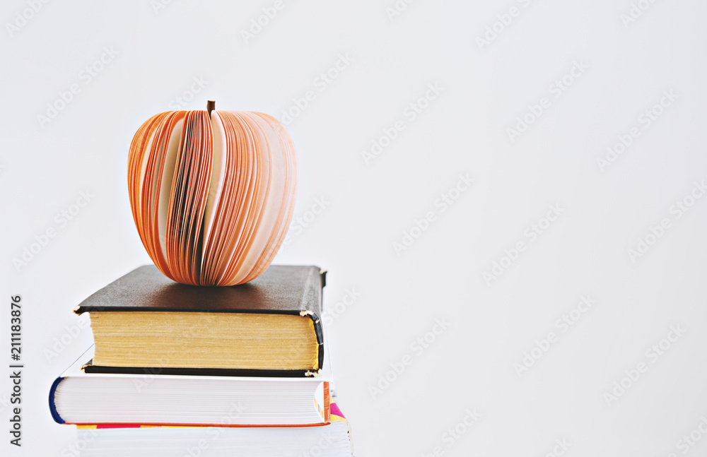 Pile of text books with fake paper apple isolated on white background ...