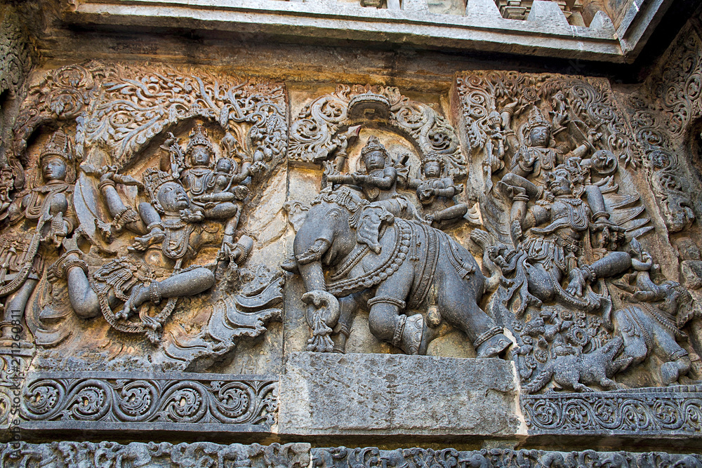 Ornate wall panel reliefs depicting from left Garuda carrying Vishnu ...