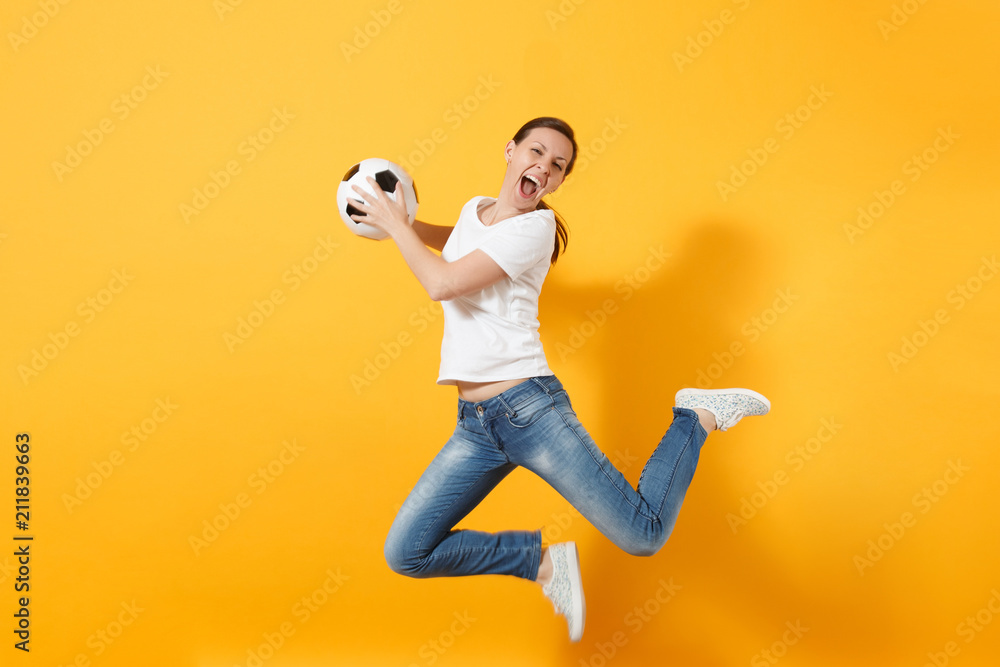 Young fun expressive European woman football fan jumping in air, cheer ...