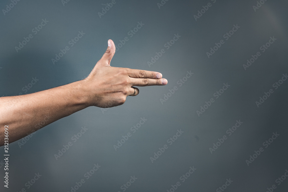 Hand showing side view of a gun Stock Photo | Adobe Stock