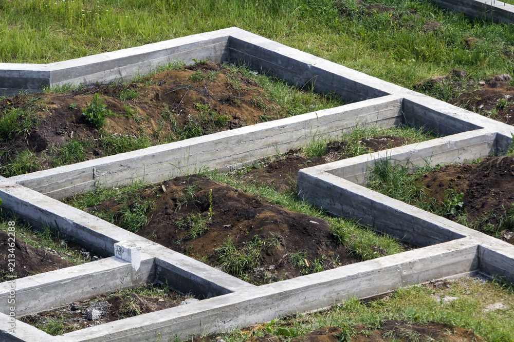 Building site in green field. Close-up detail of trenches dug in ground ...
