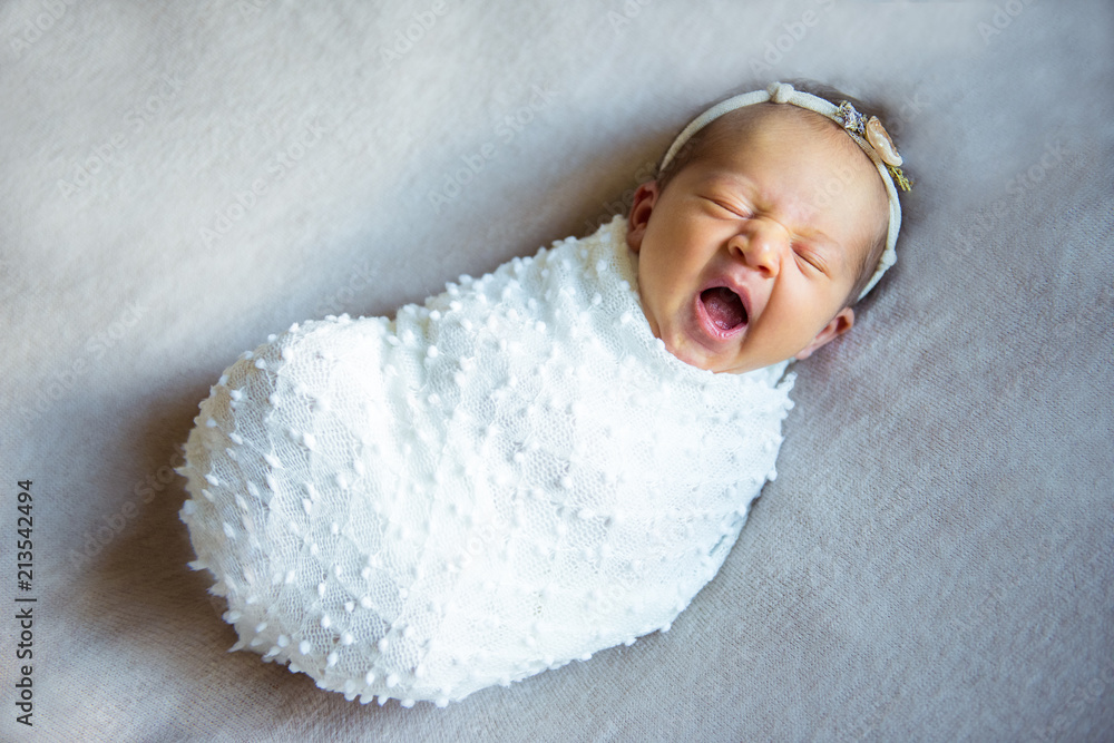 Newborn baby girl sleeping and yawning wrapped in a cocoon Stock Photo ...
