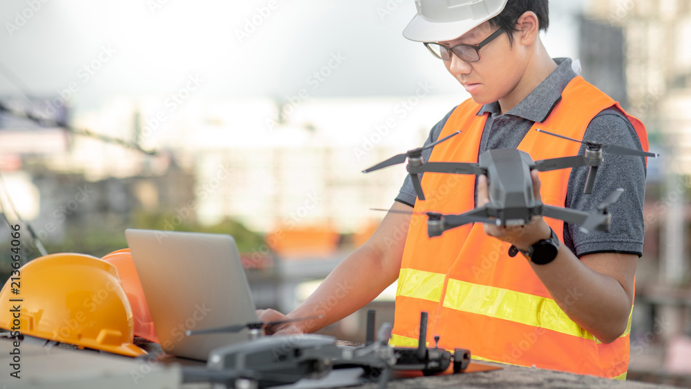 Young Asian engineer man working with drone laptop and smartphone at ...