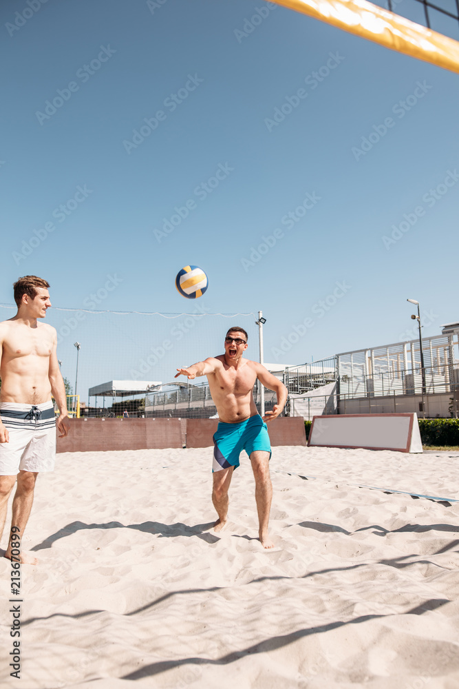 Beach Volleyball Amateur Team Players In Action At Sunny Day Under Blue