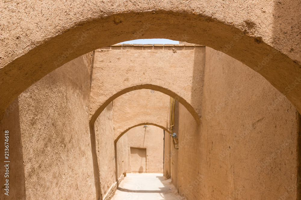 Old narrow beautiful streets of old town in Yazd, Iran. Poor houses ...