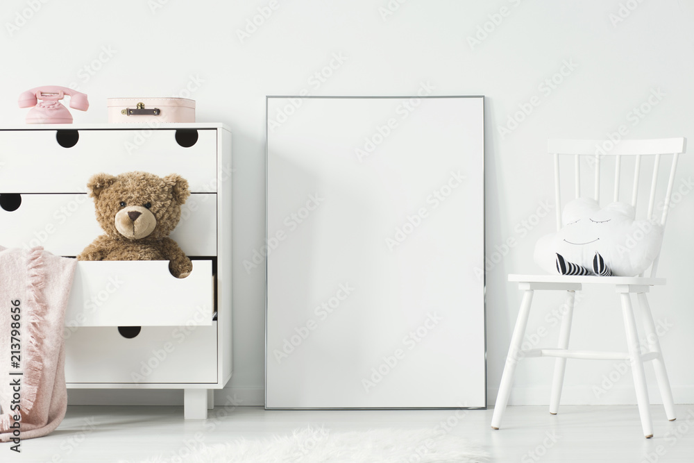 Mockup of white empty poster between chair and cabinet in child's room ...