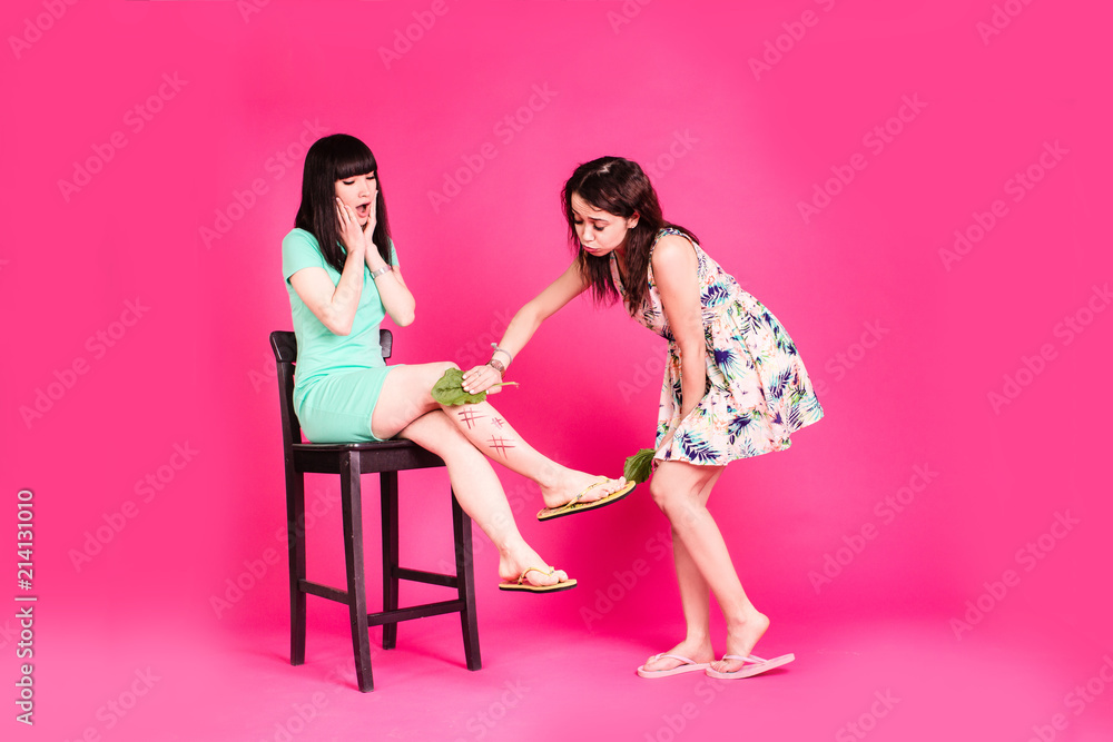 Shocked girl looking hair on her legs.the second girl blurs the scars ...