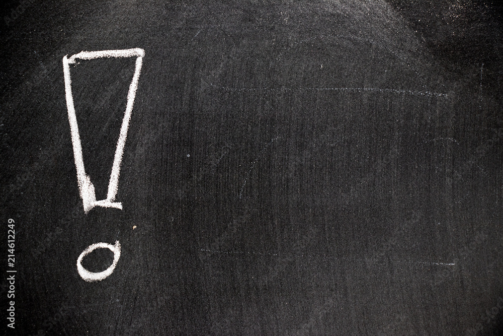White color chalk hand drawing in exclamation mark with blank space ...