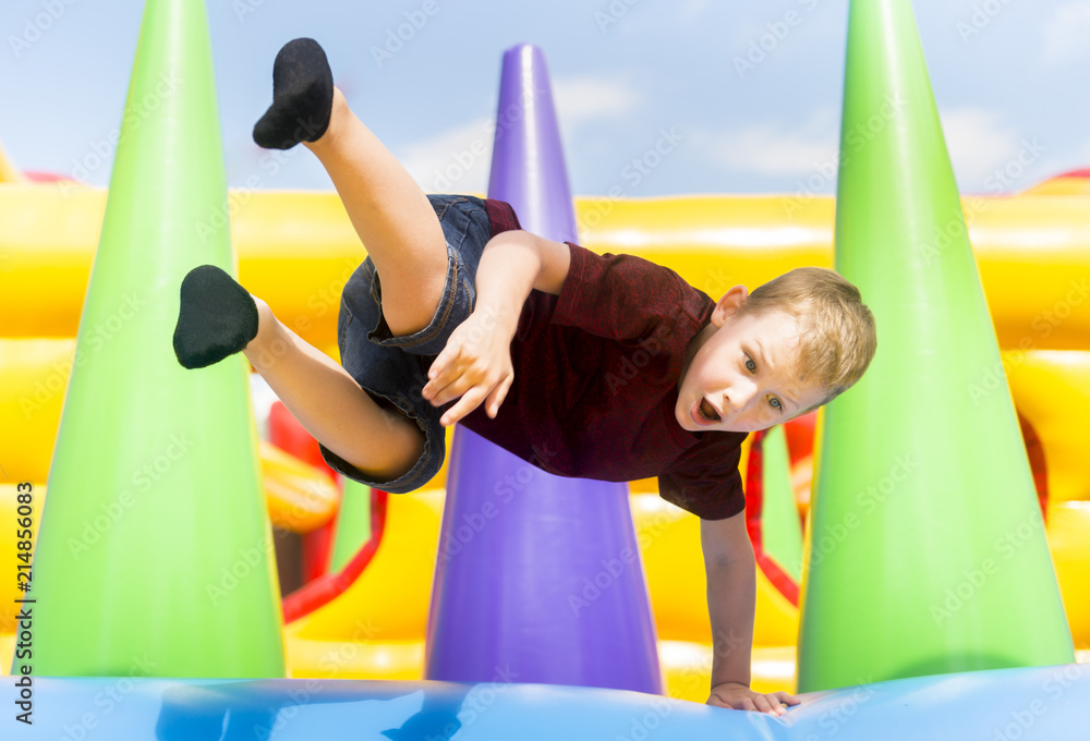 Child jumping on colorful playground trampoline. Kids jump in ...