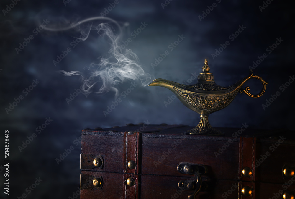 Image of magical mysterious aladdin lamp with smoke over black ...