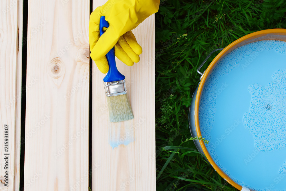 Stock-Foto „Yellow gloved hand start to paint or priming with ...