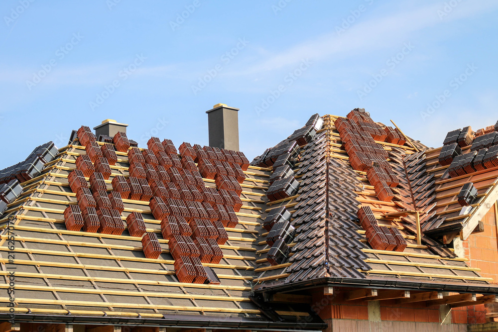 Roof of a detached house under construction with tiles ready to be laid ...