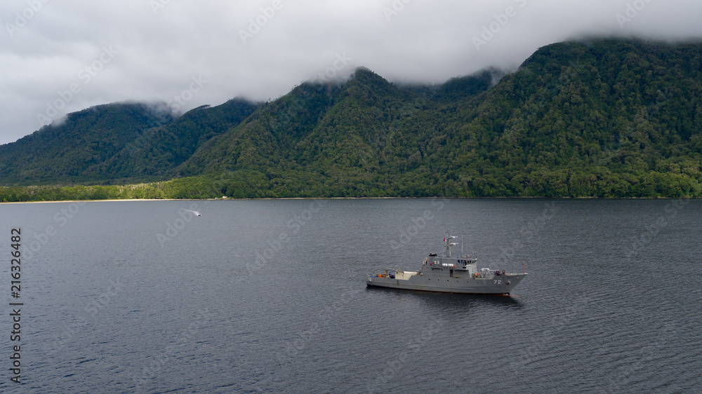Ship in mooring maneuver, in the Slight bay in southern Chile. Near the ...