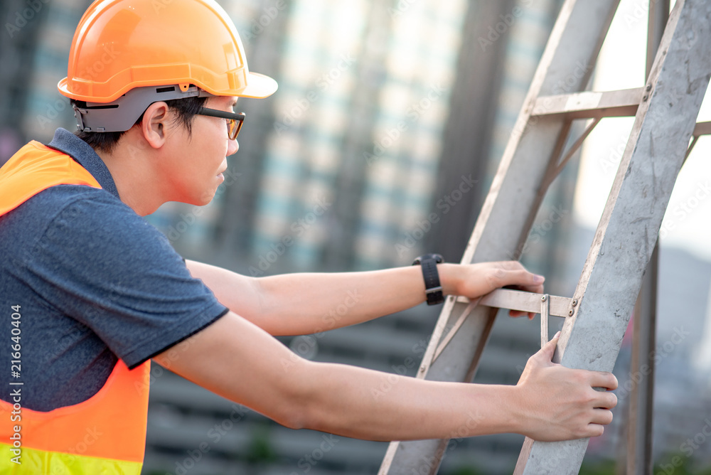 Young Asian maintenance worker man with orange safety helmet and vest ...