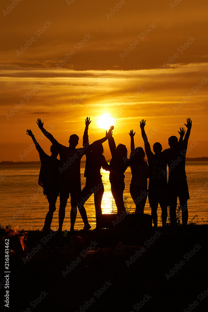 Group of happy friends hands up against the sunset. Stock Photo | Adobe ...
