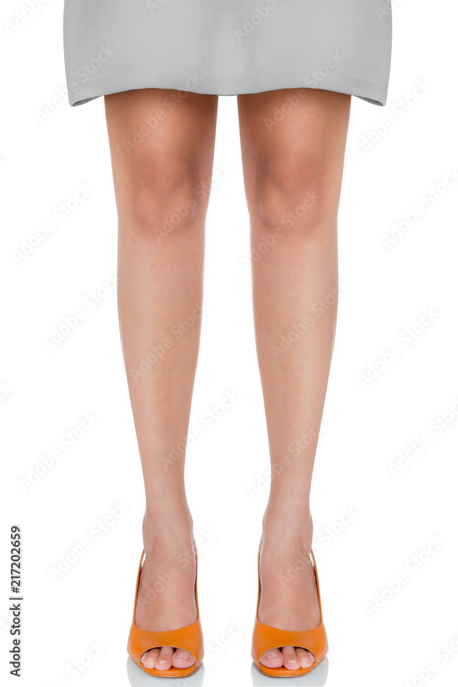 Woman beautiful long legs, standing pose and feet wearing leather high ...