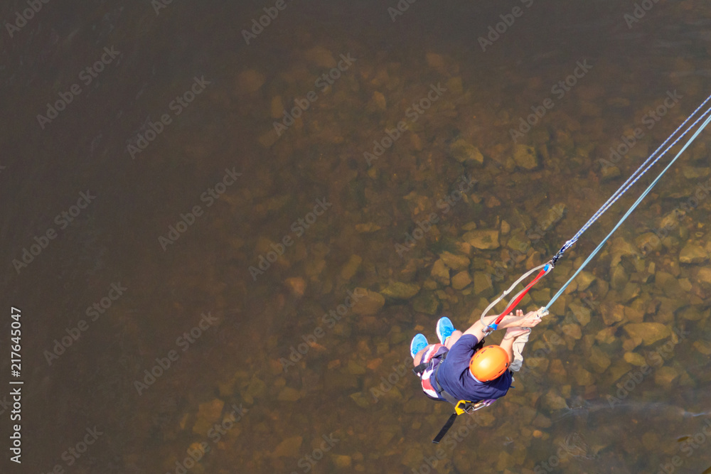 Rope jumping from high altitude of bridge. Bungee jumping from ...