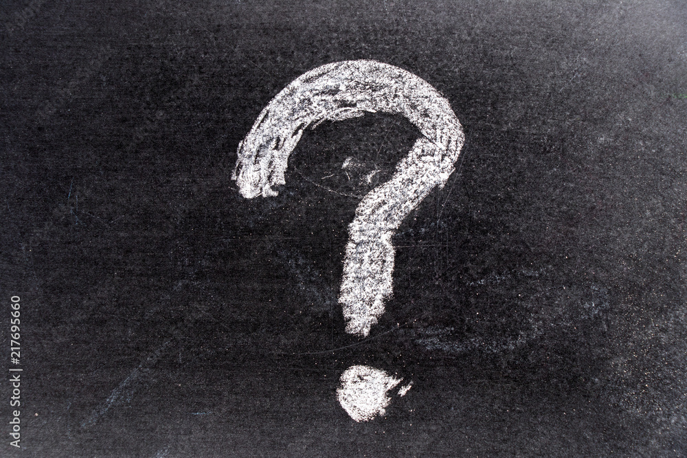 White color chak hand drawing in question mark shape on blackboard ...