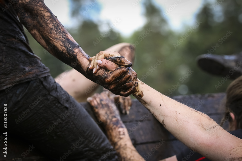 Mud race runners during extreme obstacle races Stock Photo | Adobe Stock
