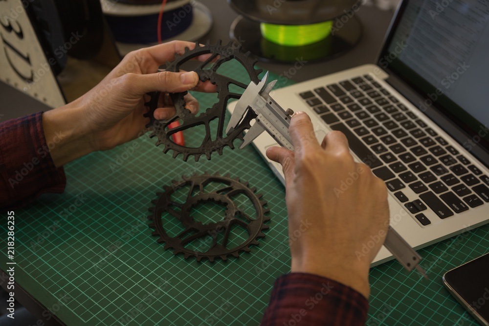 Mechanic checking diameter of chain ring with vernier calipers Stock ...