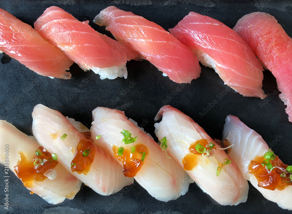 Rows of fresh Japanese Akami Nigiri Sushi (Makuro) and Hamachi ...