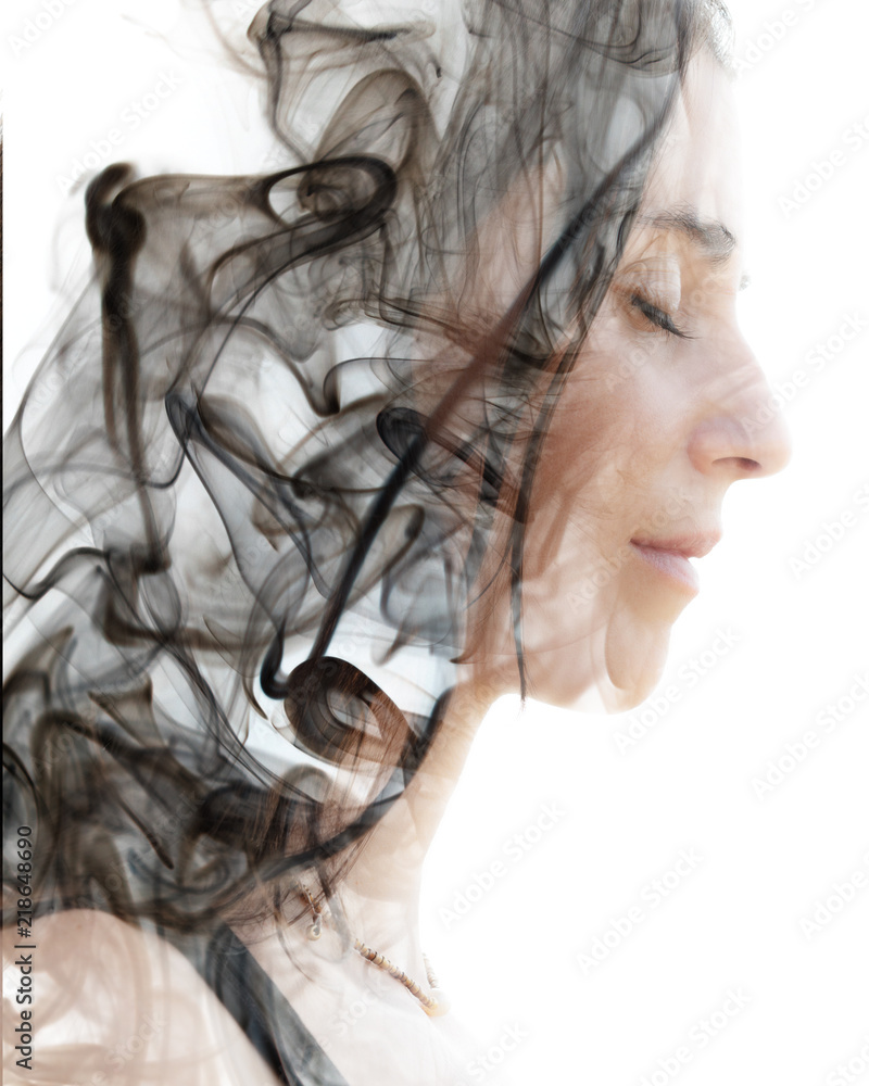 Double exposure portrait of a young woman and a smoky texture ...