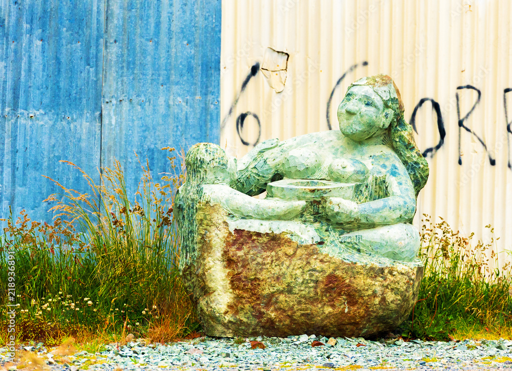 Sculpture of a woman with a child on a city street, Puerto Natales ...