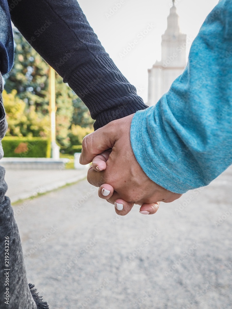 Girl and boy holding hands, romantic on the background of a beautiful ...